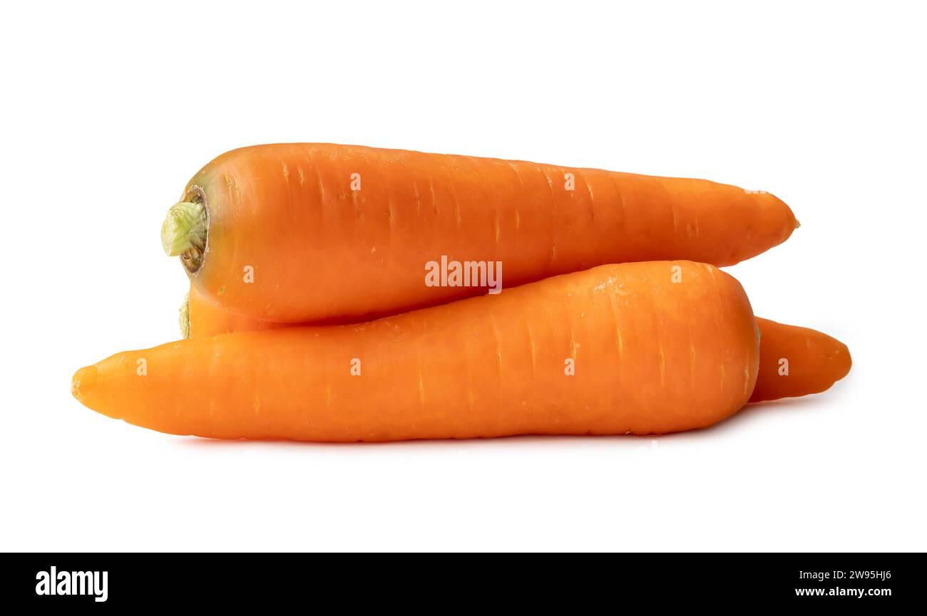 Three fresh orange carrots in stack are isolated on white background ...