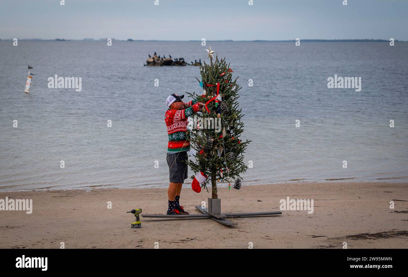 Mike Womack, 52, puts the final touches on a Christmas tree along ...