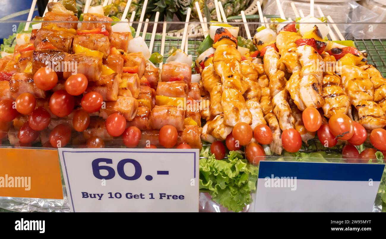 Delicious barbeque food with buy ten get one free sign is on sale at ...