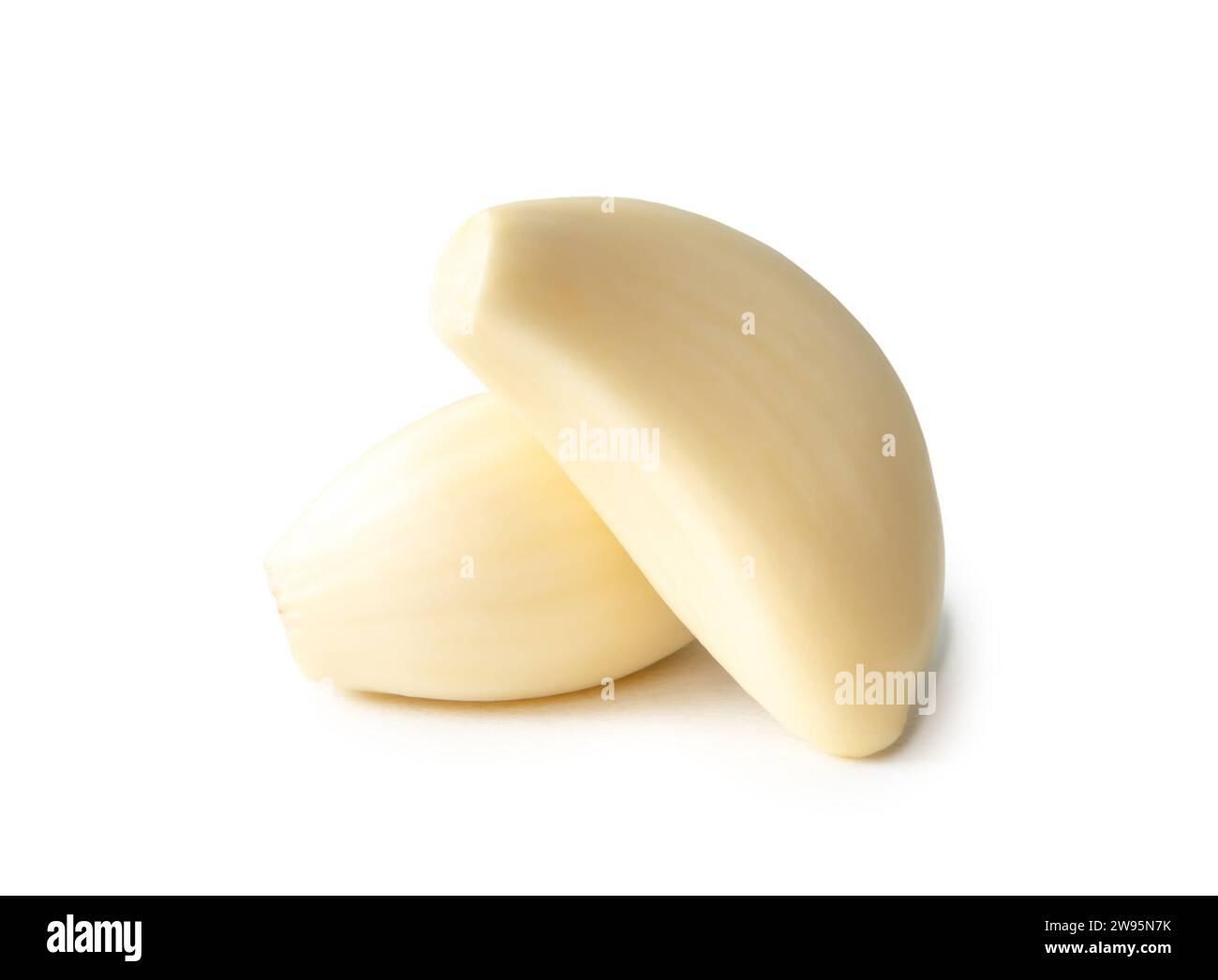 Two fresh peeled garlic cloves are isolated on white background with ...