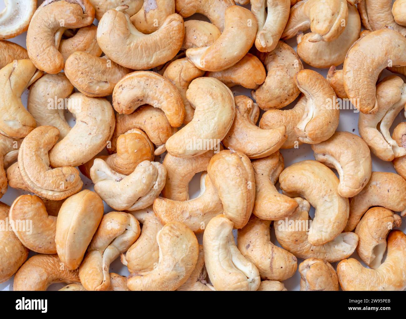 Delicious roasted brown cashew nut is used as snack background texture ...
