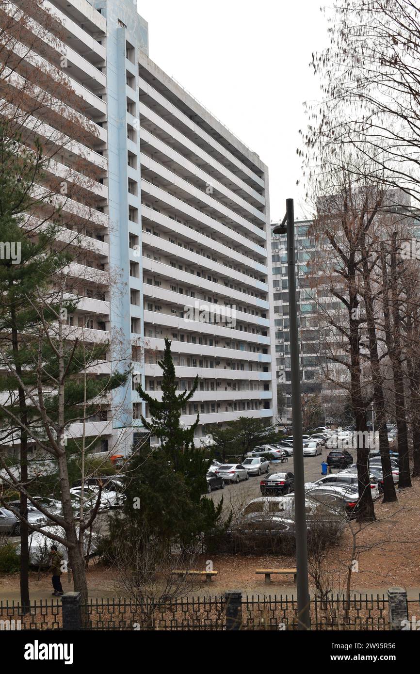 View of residential buildings and parking lot with parked cars in ...