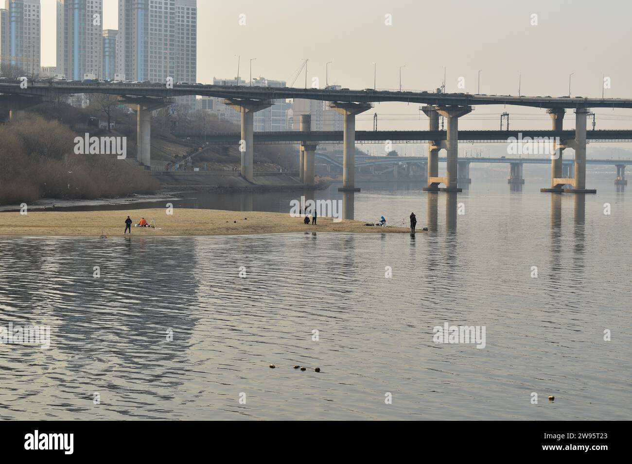 Local Koreans fishing from the sand banks of the river Han with the ...