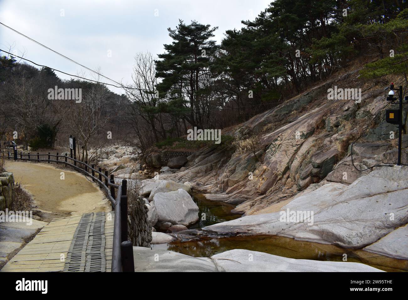 Rocky frozen river bed running along a walking trail in Bukhansan ...