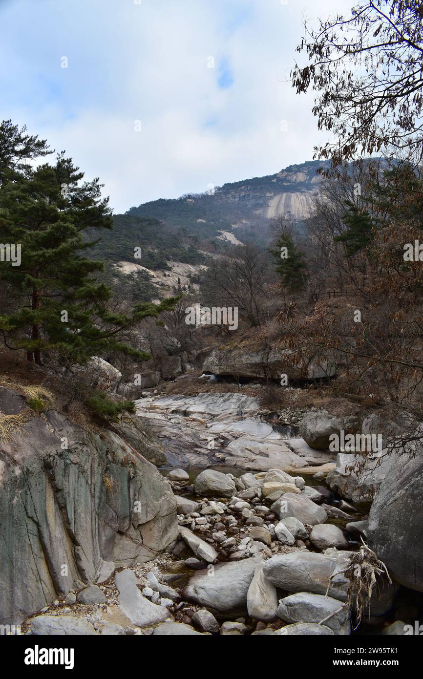 Rocky frozen river bed running along a walking trail in Bukhansan ...