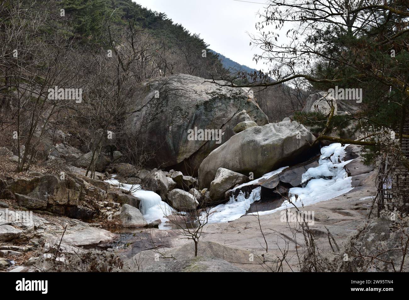 Rocky frozen river bed running along a walking trail in Bukhansan ...