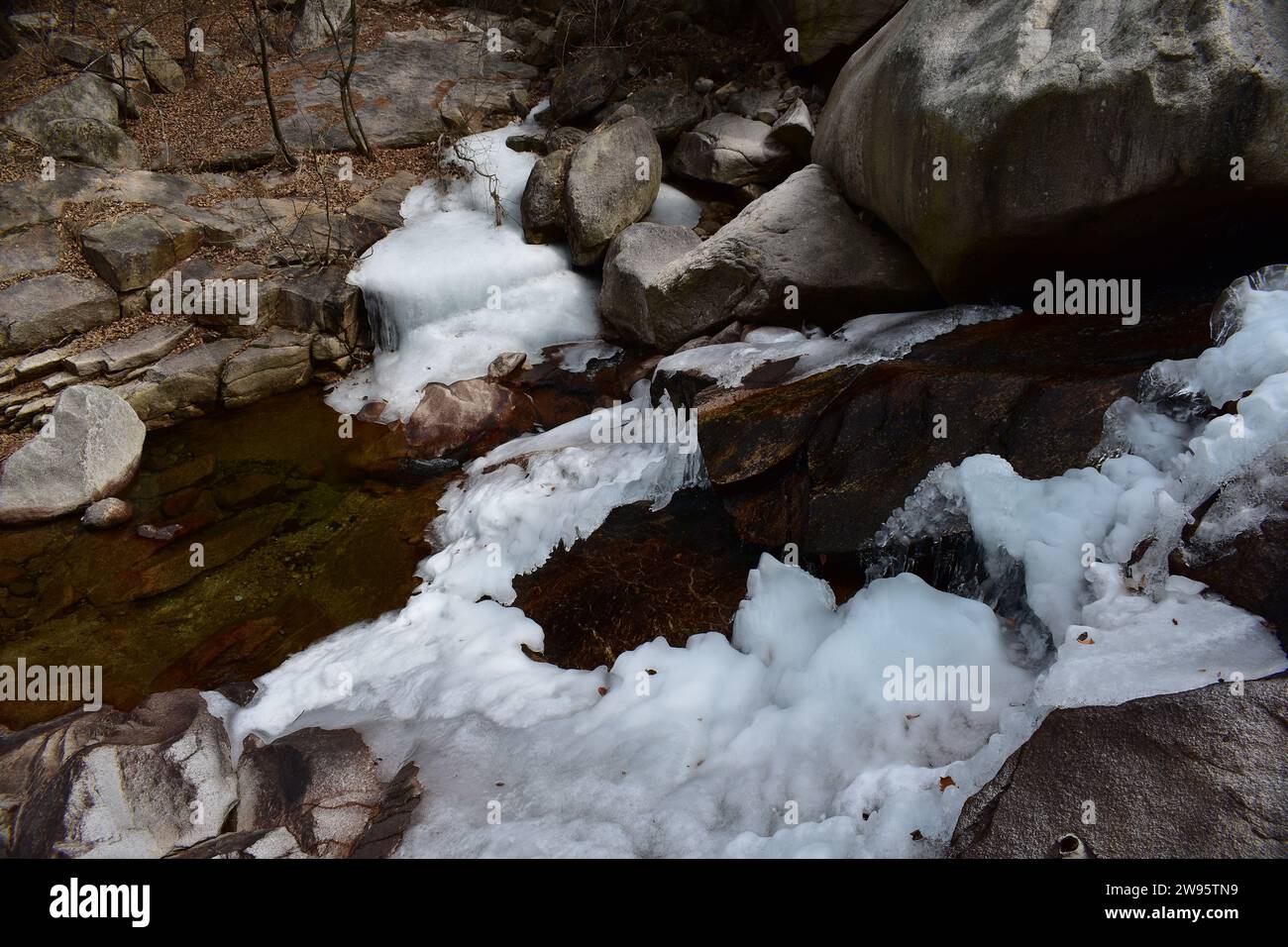 Rocky frozen river bed running along a walking trail in Bukhansan ...