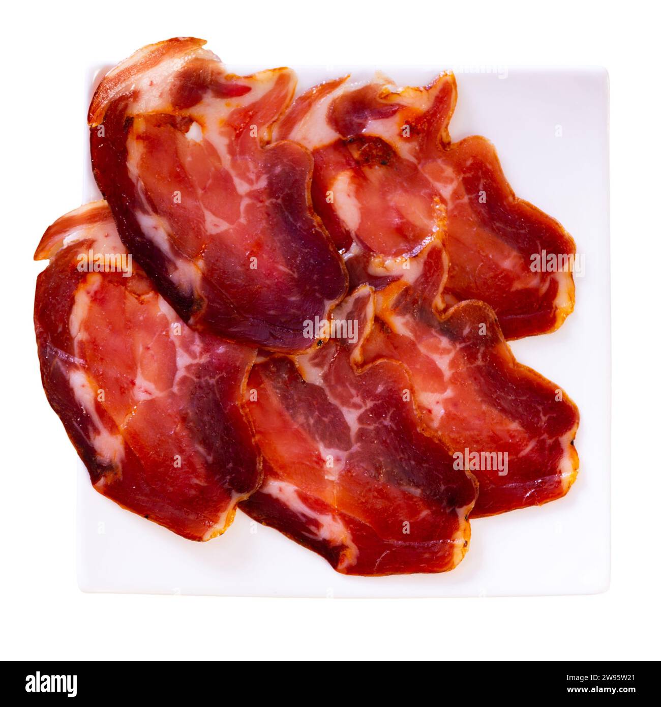 Sliced Spanish dry cured pork neck on plate. Traditional meat ...