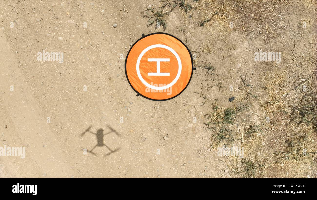 Top view of a drone landing strip and the shadow of a drone preparing ...
