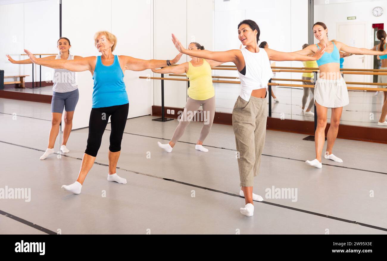 Group of active women practicing energetic dance in a studio Stock ...