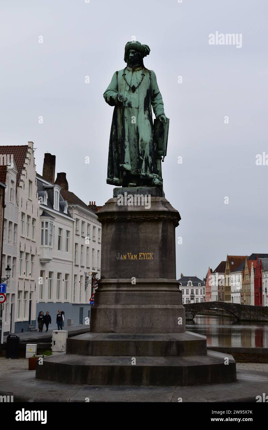 The green oxidized copper statue of Belgian painter Jan Van Eyck on a ...