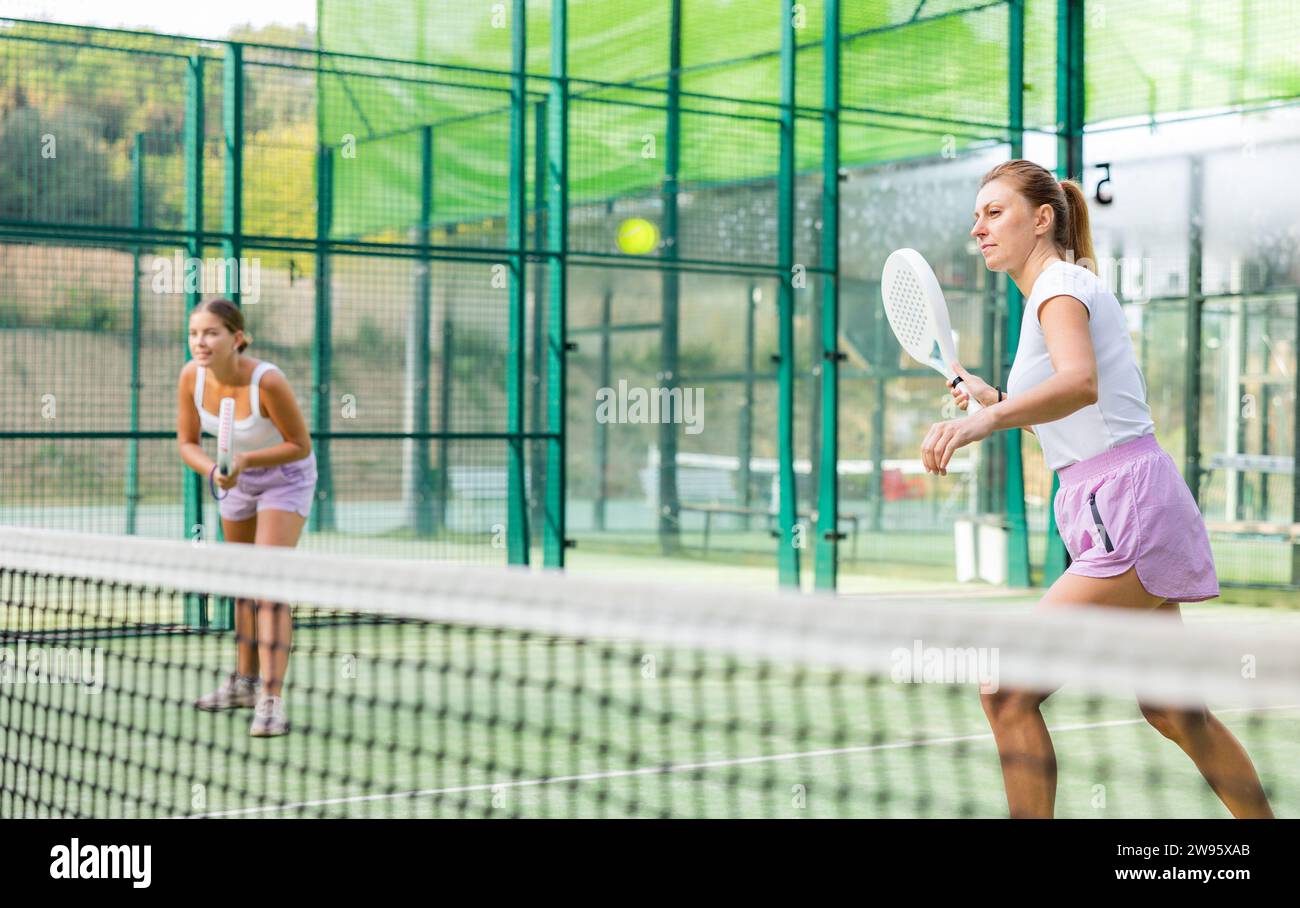 Two women tennis players playing padel Stock Photo - Alamy
