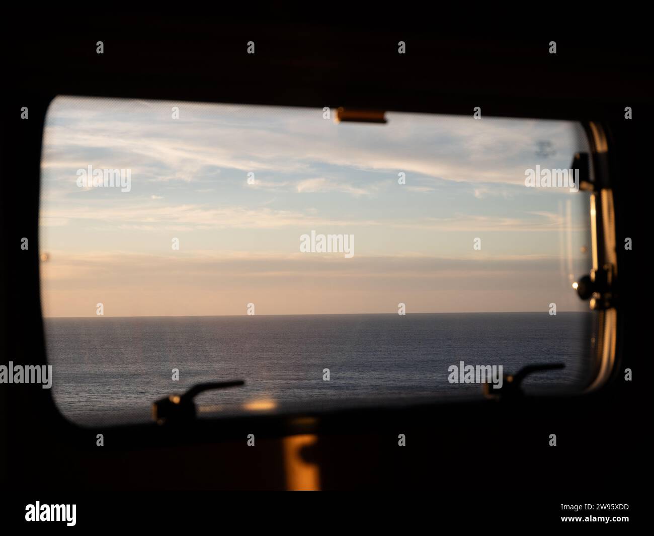 Sunrise views to the ocean and the sky through the window of the camper ...