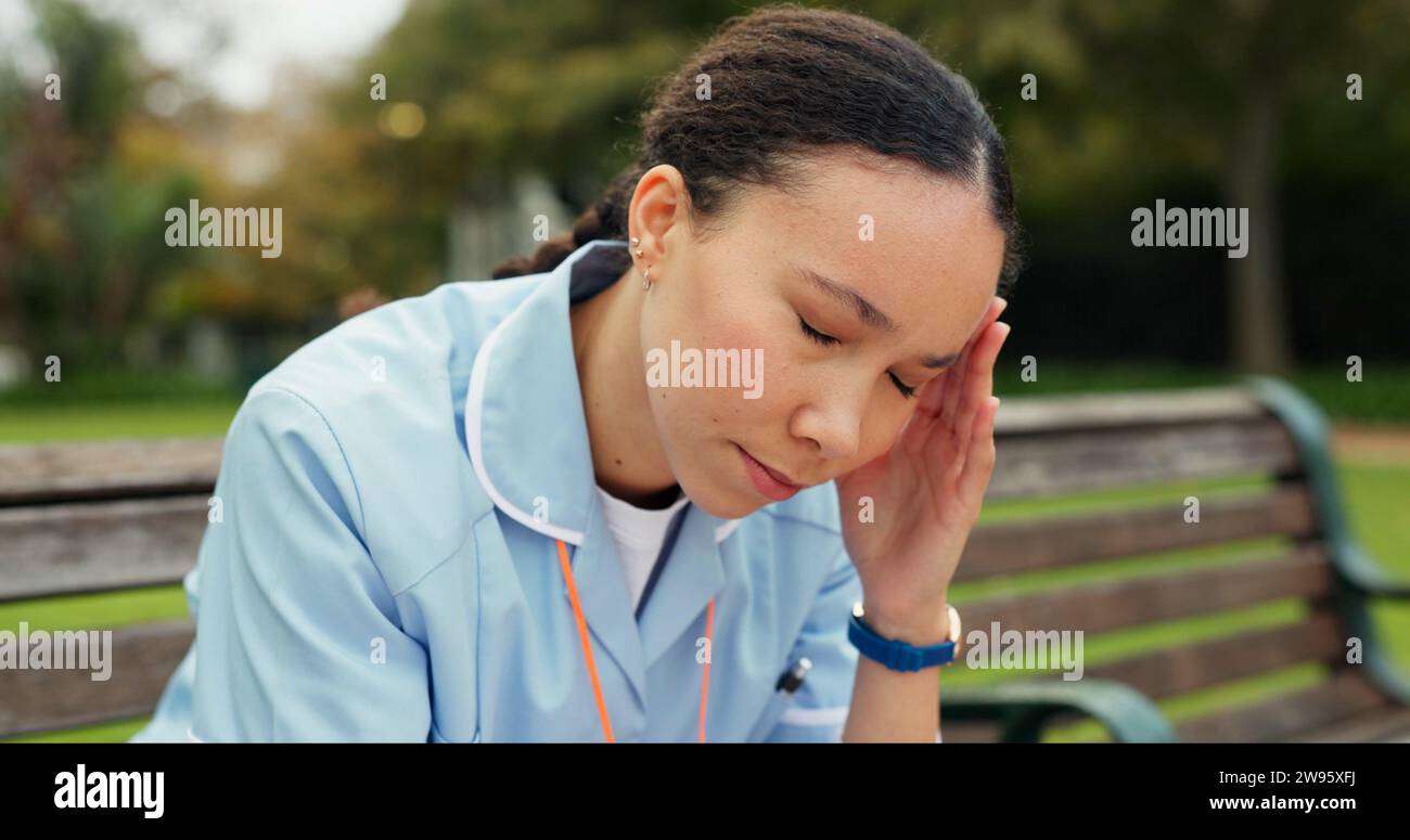 Headache, tired and nurse with woman on park bench for thinking ...