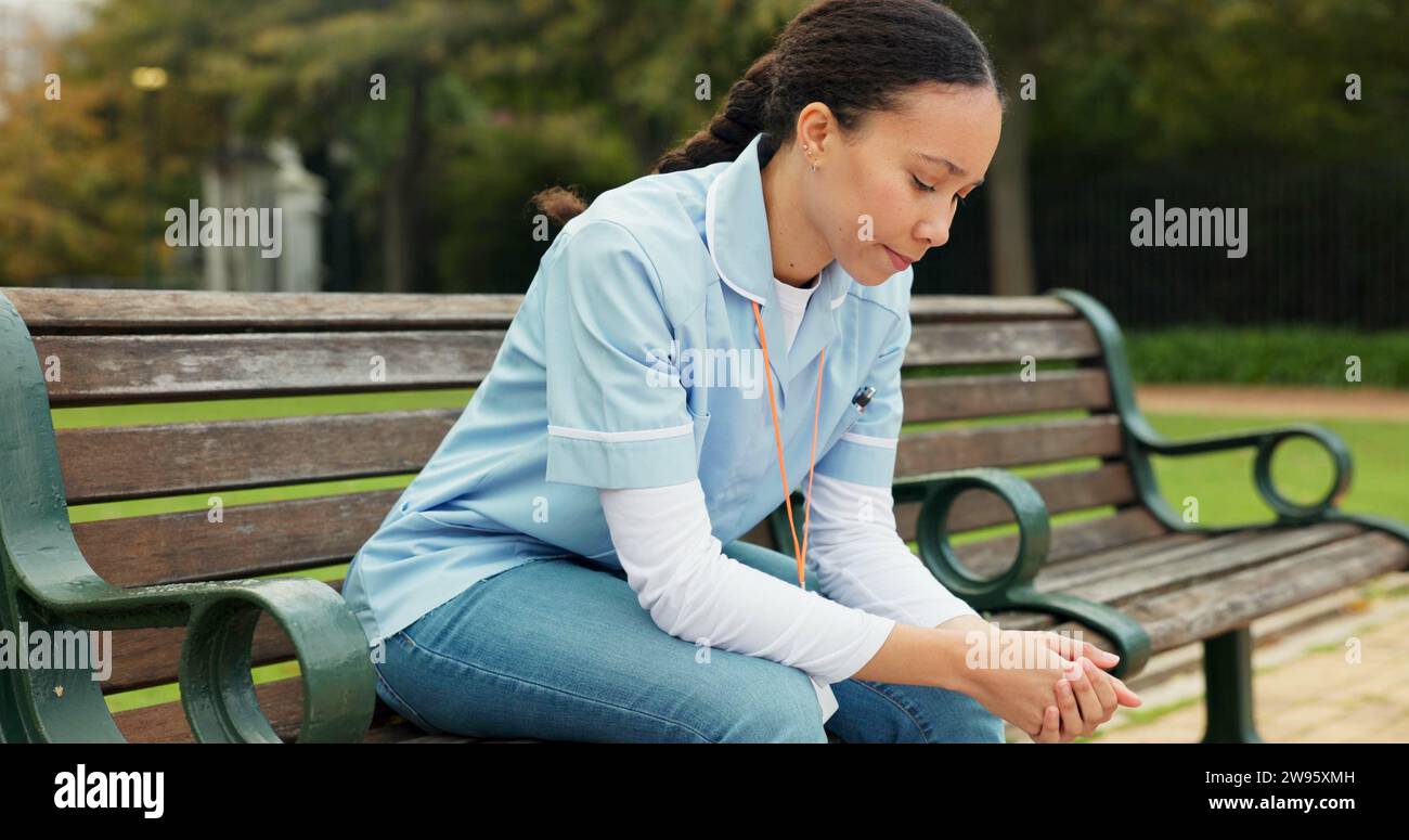 Sad, tired and nurse with woman on park bench for thinking, fatigue and ...