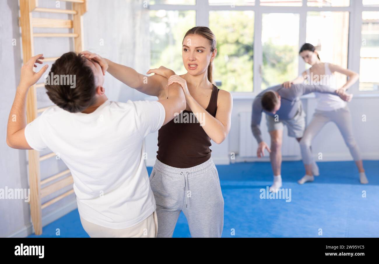 Young girl practicing self-defense techniques in pairs with guy Stock ...