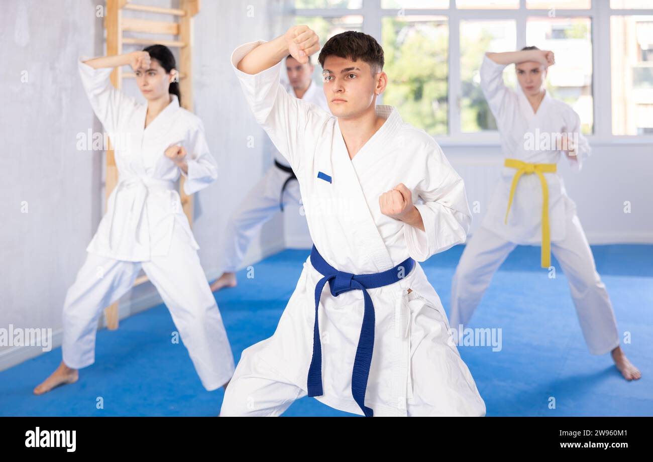 Middle-aged man attendee of karate classes practicing kata standing in ...