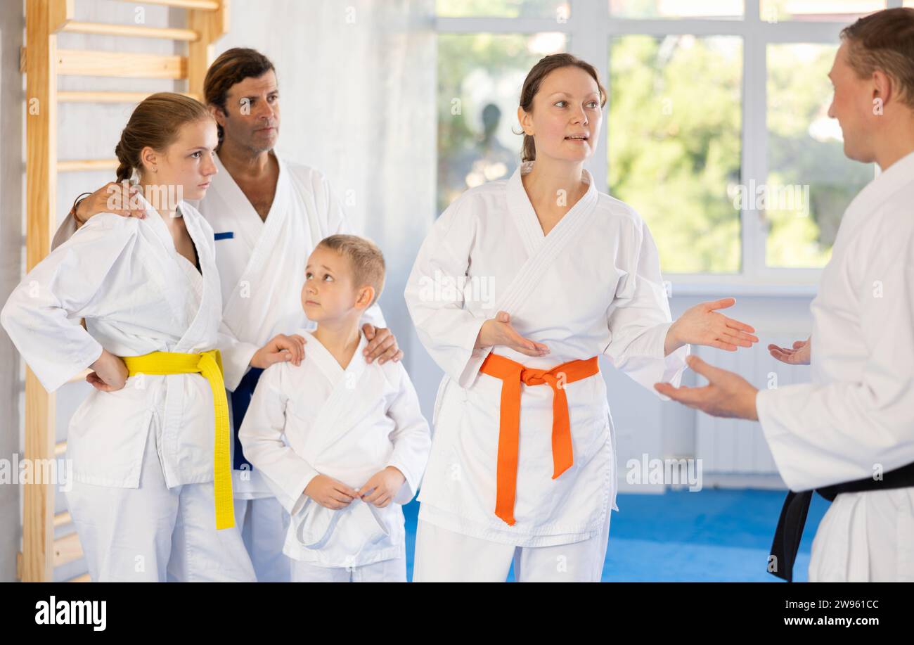 After completing family session and karate training, parents talk with ...