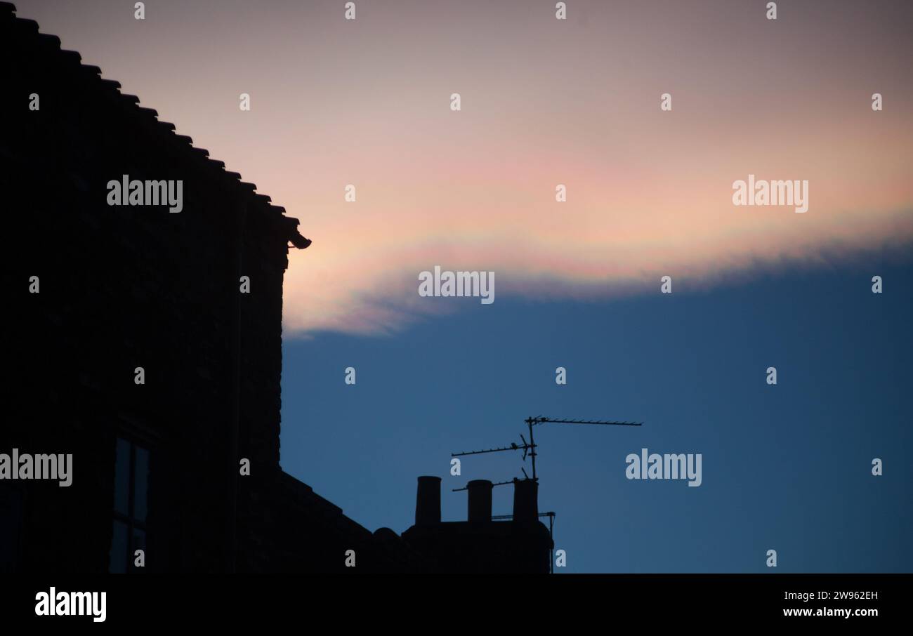 Winter sunset with rare high nacreous iridescent clouds optical effect ...