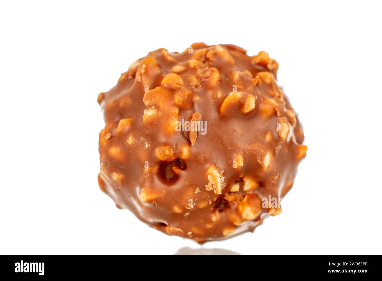 One chocolate candy with a nut, macro, isolated on a white background ...
