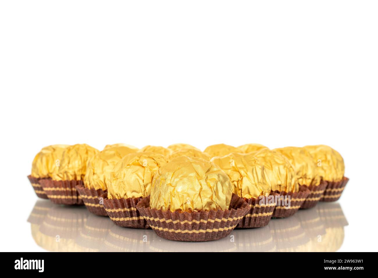 Several chocolate candies with a nut in a paper wrapper, macro ...