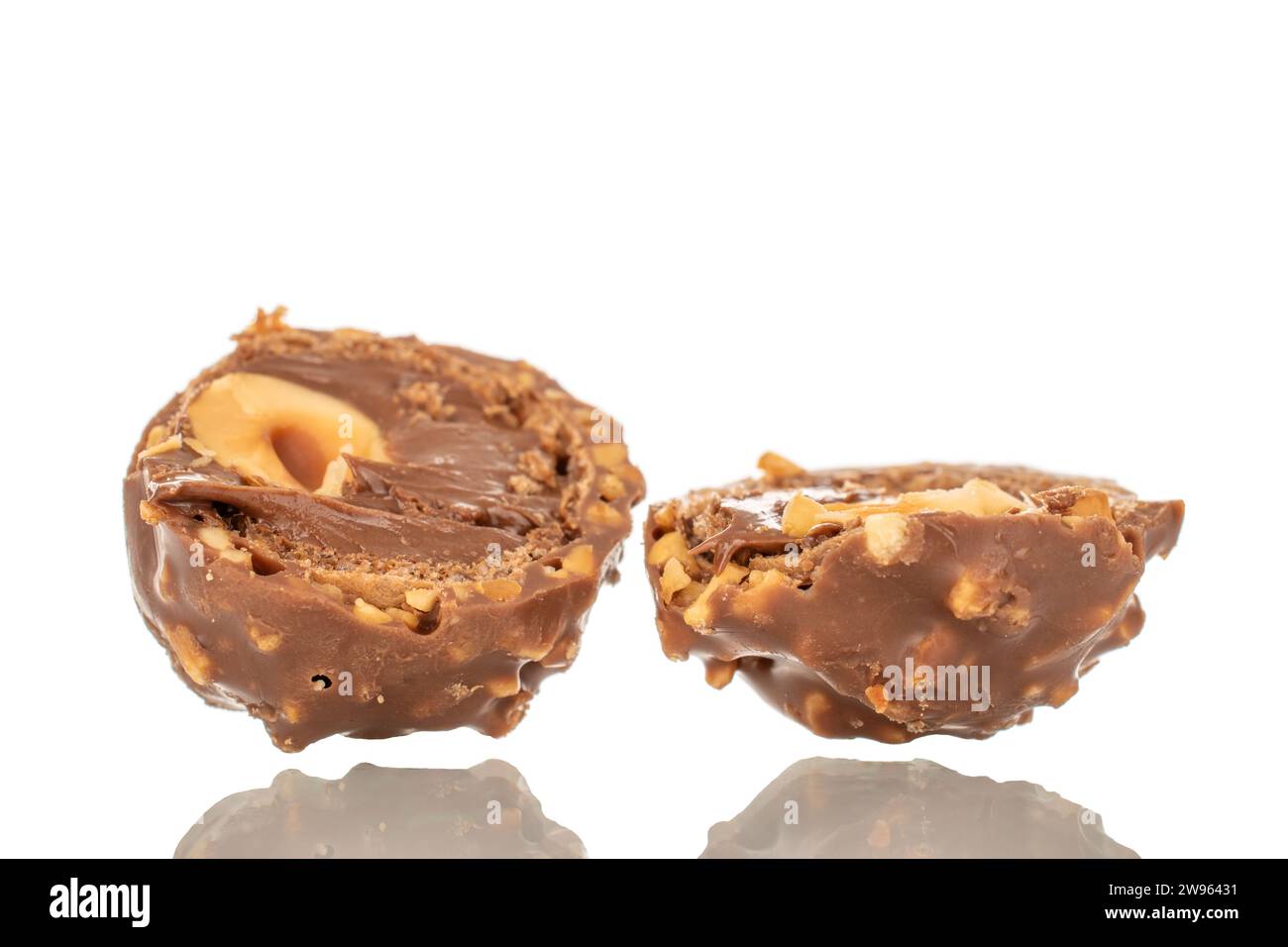 Two halves of a chocolate candy with a nut, macro, isolated on a white ...