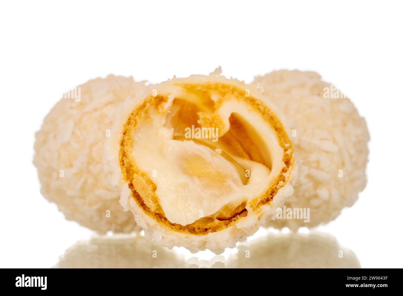 One half candy with nut and coconut flakes and two whole candies, macro ...