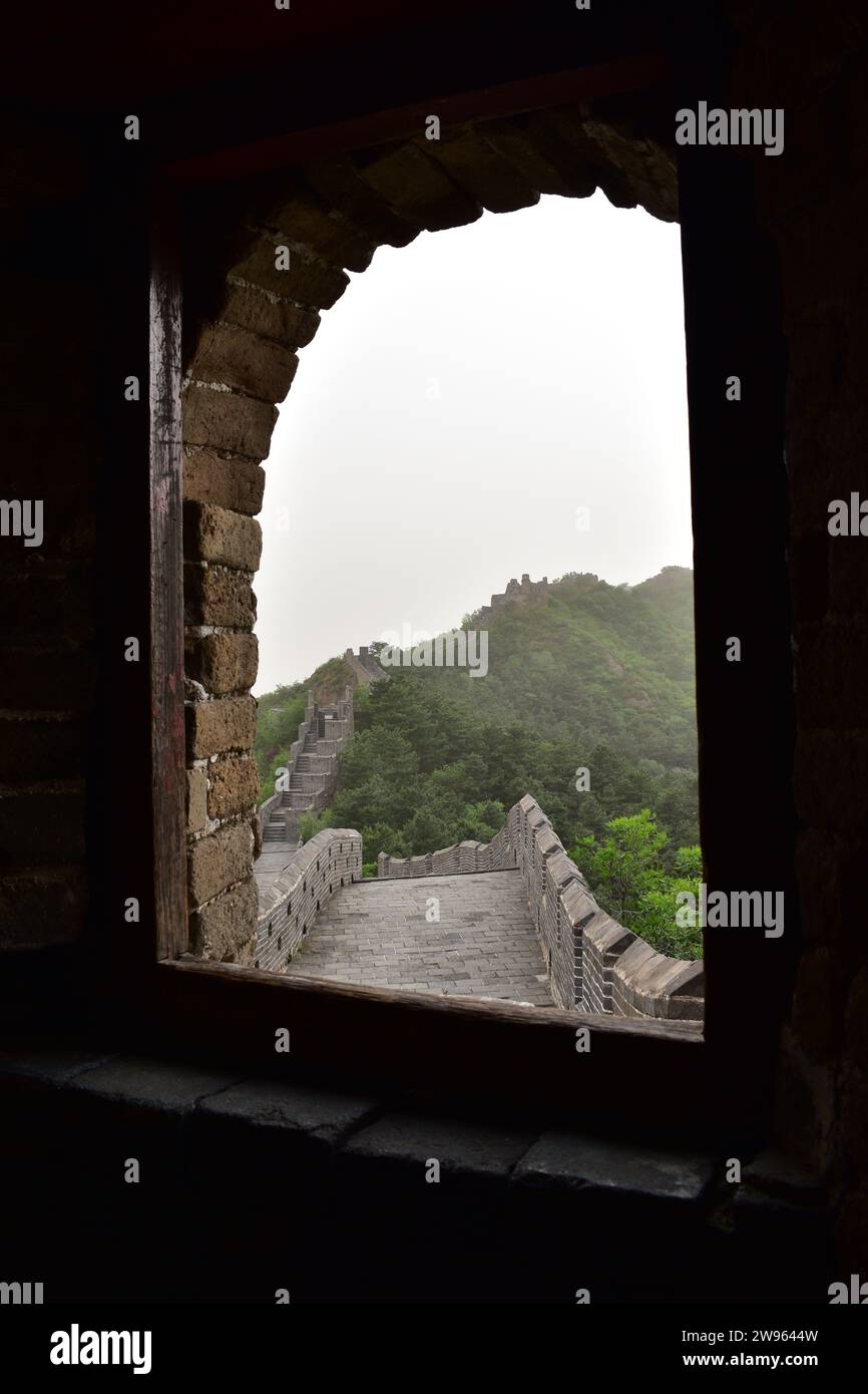 Part of the Great Wall of China as seen through the stone window of a ...