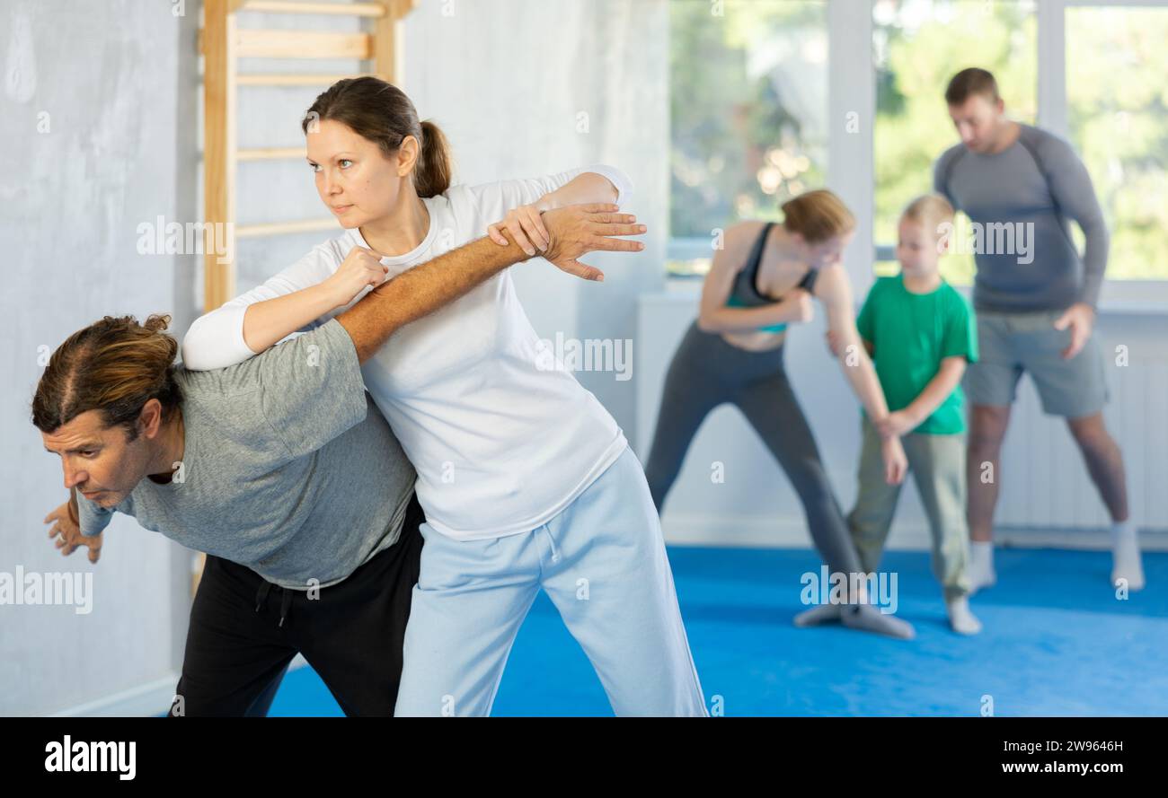 Woman in gym perform basic elements of krav maga self-defense system ...