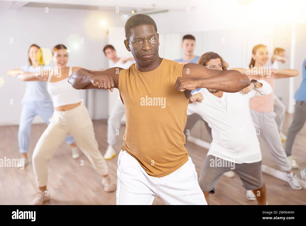 Group of smiling people of different ages dancing and practicing new ...
