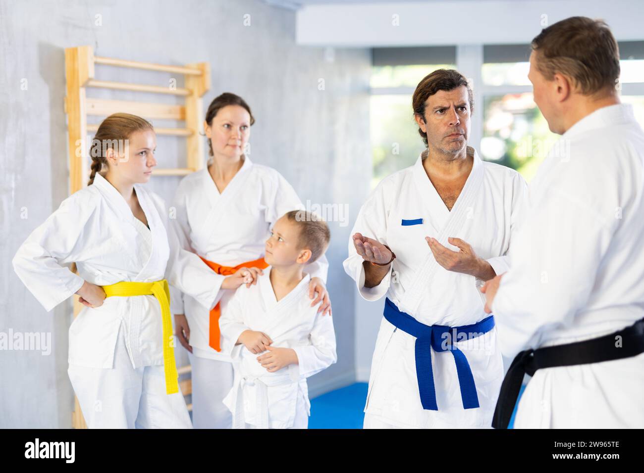 After completing family session and karate training, parents talk with ...