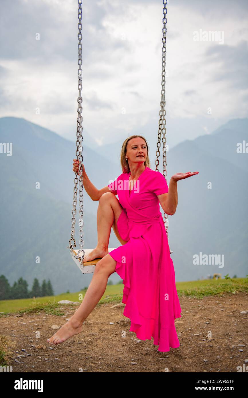 Blissful moments in the air, a girl in a pink dress on a swing Stock ...