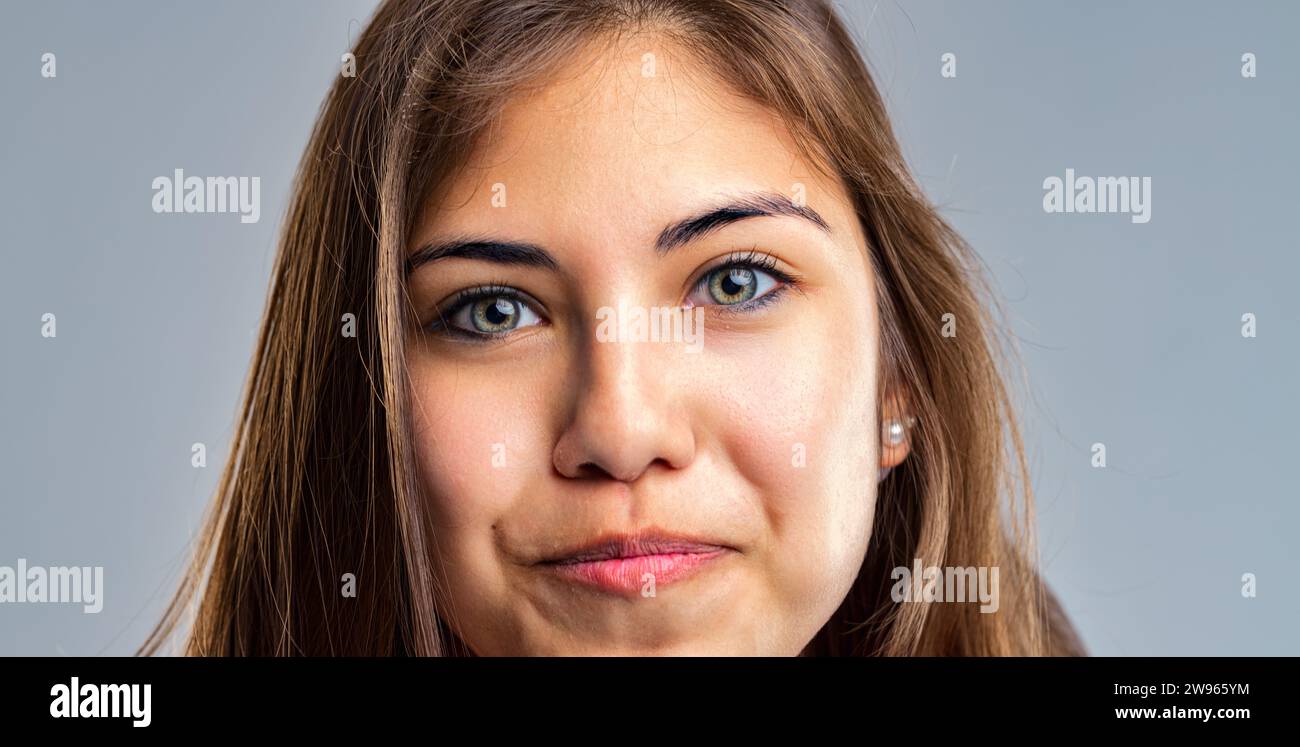 Close-up portrait of a woman with a playful smirk, her eyes sparkling ...