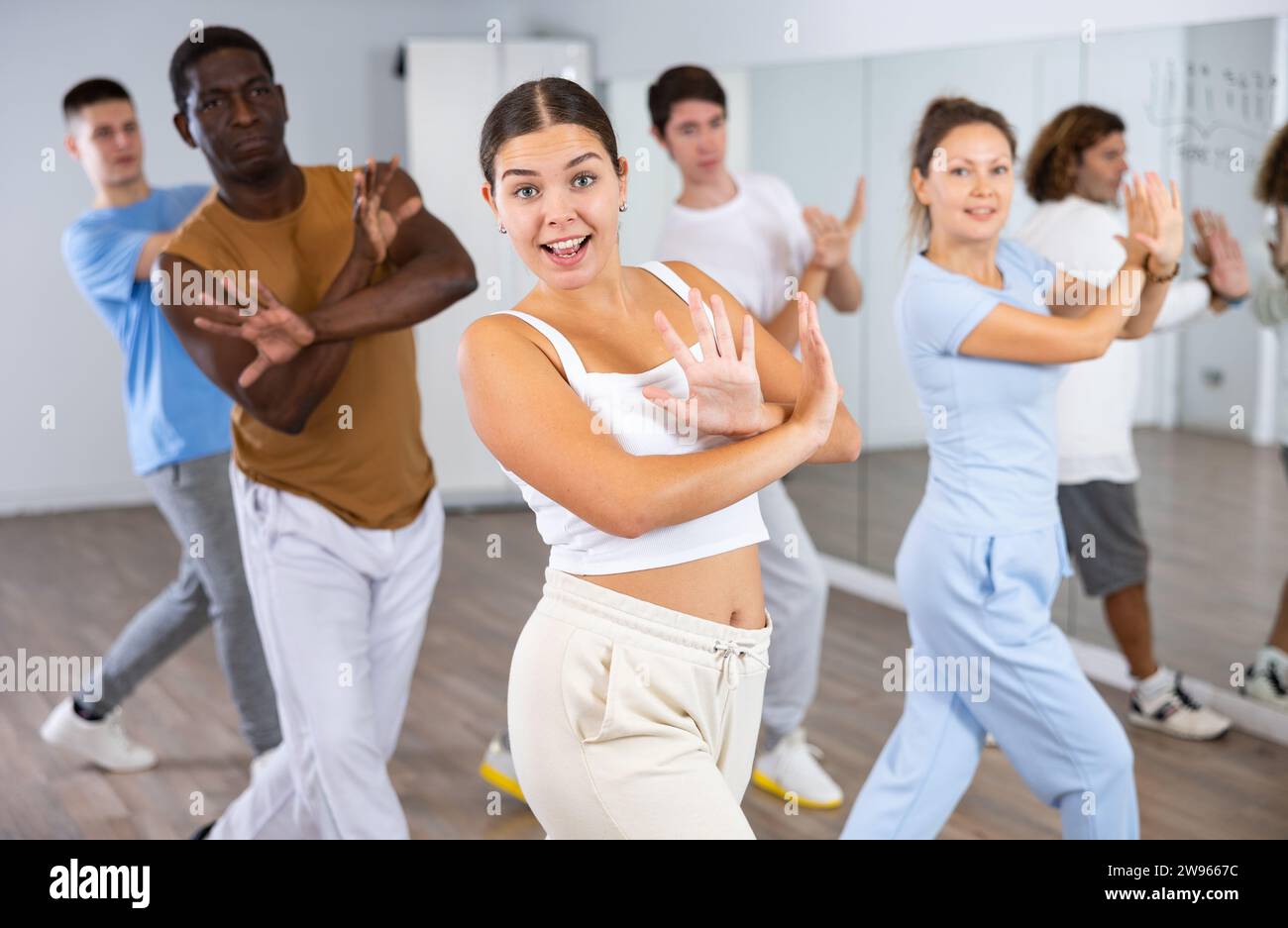 Group of international people dancing in gym with crossed hands. The ...