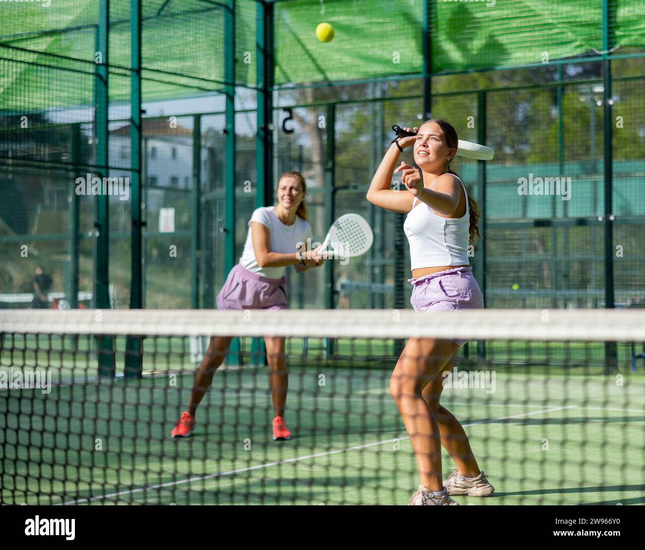Two women tennis players playing padel Stock Photo - Alamy