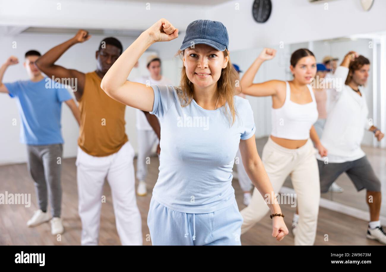 Group of different people rehearsing dance in dance studio Stock Photo ...