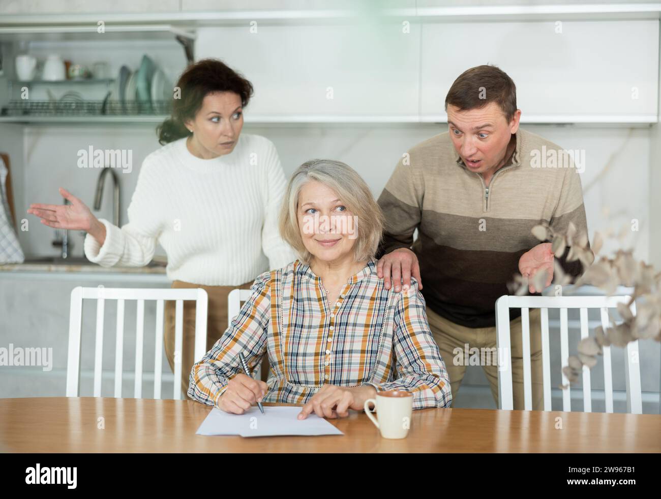 Old woman signing papers Stock Photo - Alamy