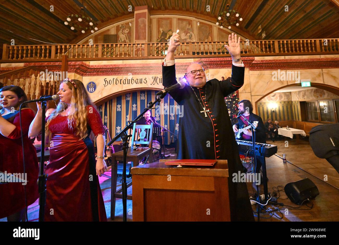 Munich, Germany. 24th Dec, 2023. Cardinal Reinhard Marx stands on stage ...