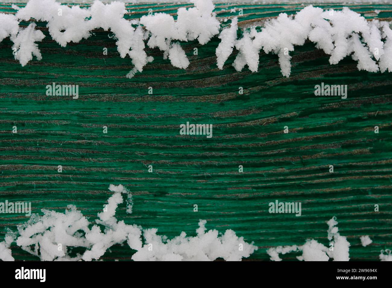 Old boards are covered with snow crystals and frost after severe frosts ...
