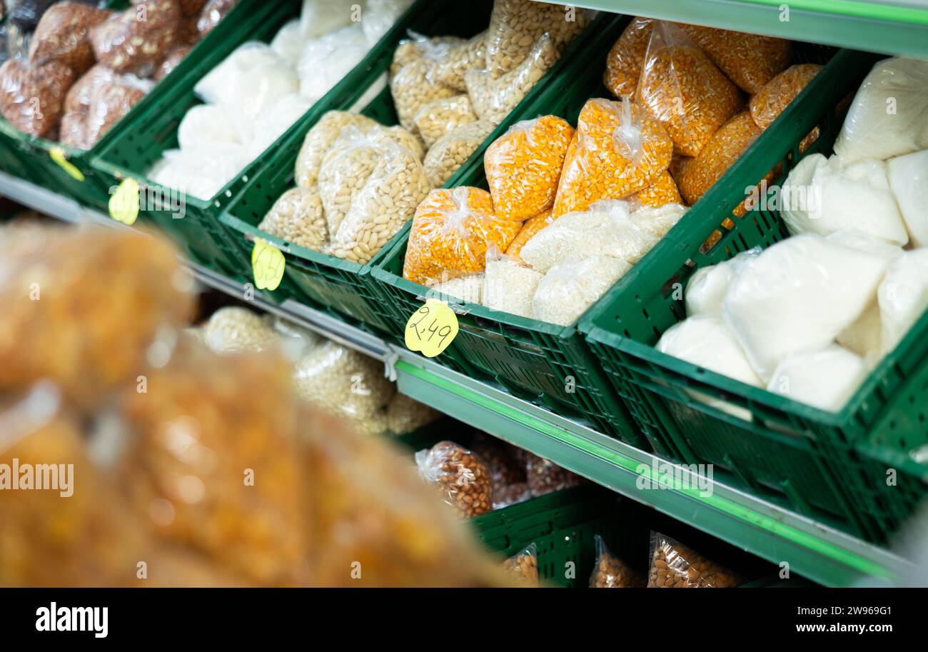 Various bulk food products, dried corn kernels and nuts, packed in poly ...