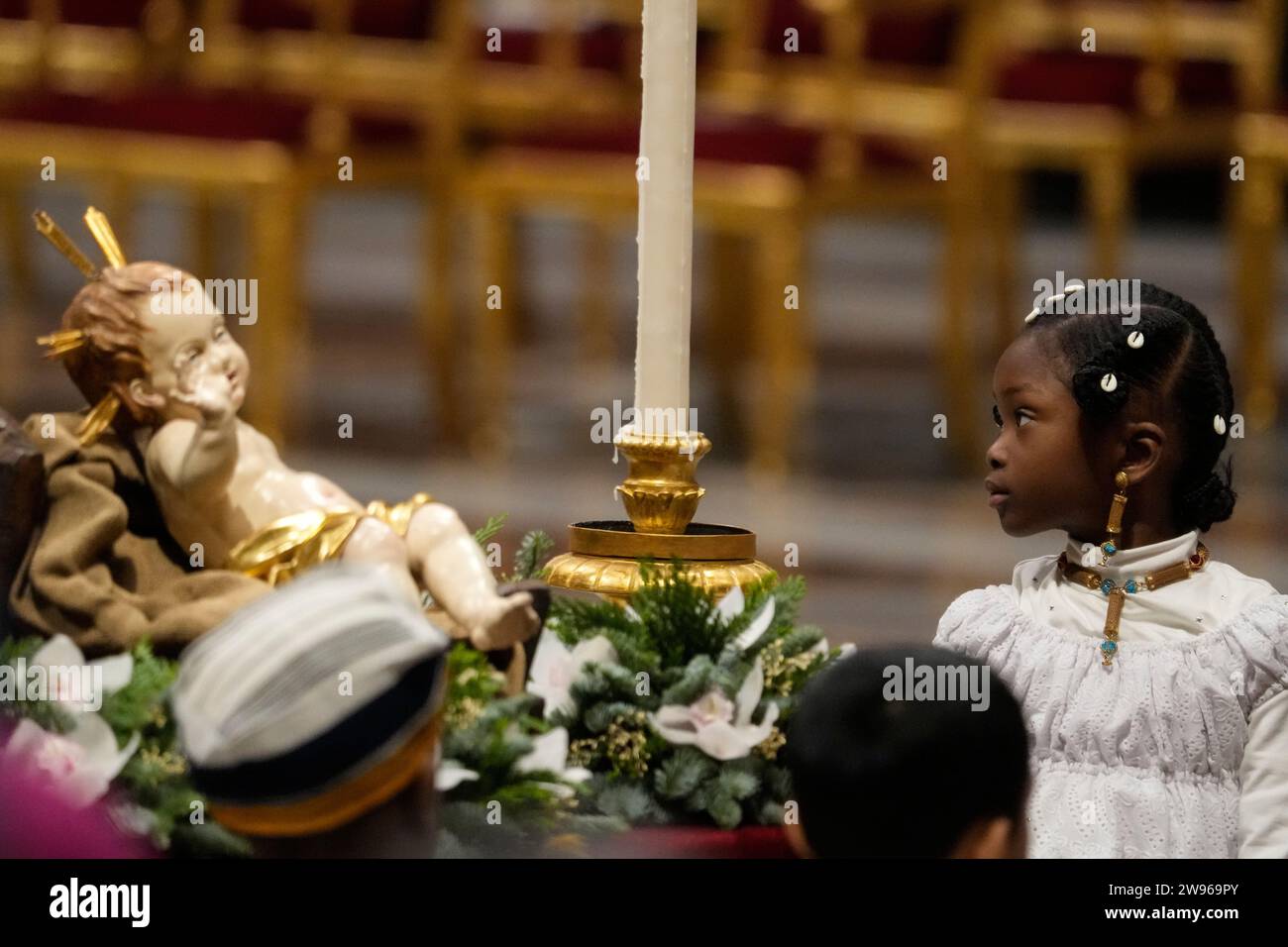 A child looks at a statue of Baby Jesus as Pope Francis presides over ...