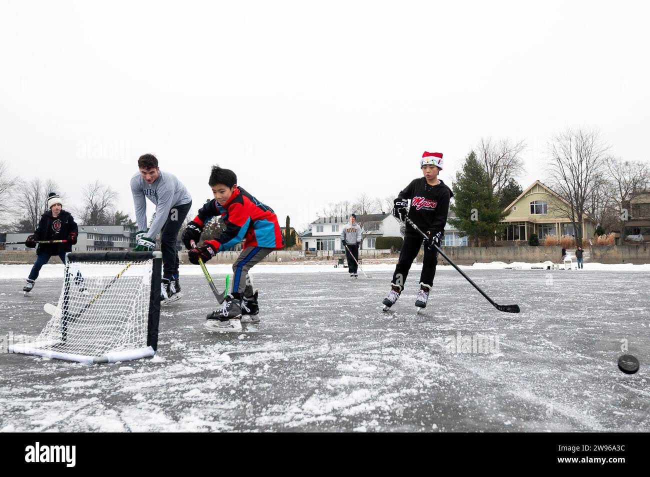 People play a game of pick up hockey on the Ottawa River near Britannia ...