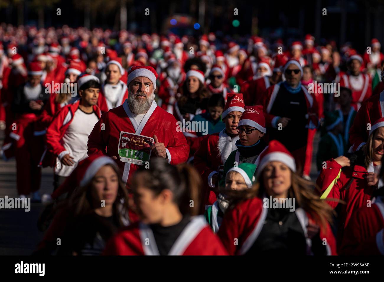 Thousands of people dressed as Santa Claus run during the traditional ...