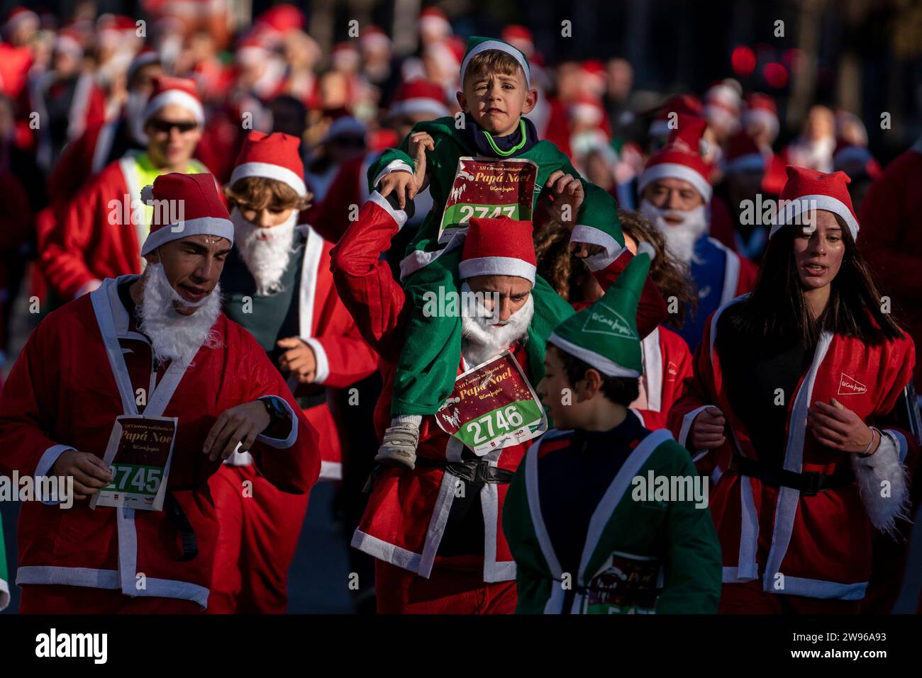 Thousands of people dressed as Santa Claus run during the traditional ...