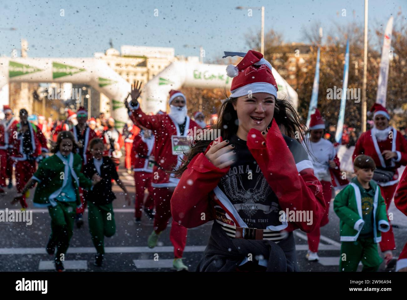 Participants dressed as Santa Claus arrive at the finish line during ...