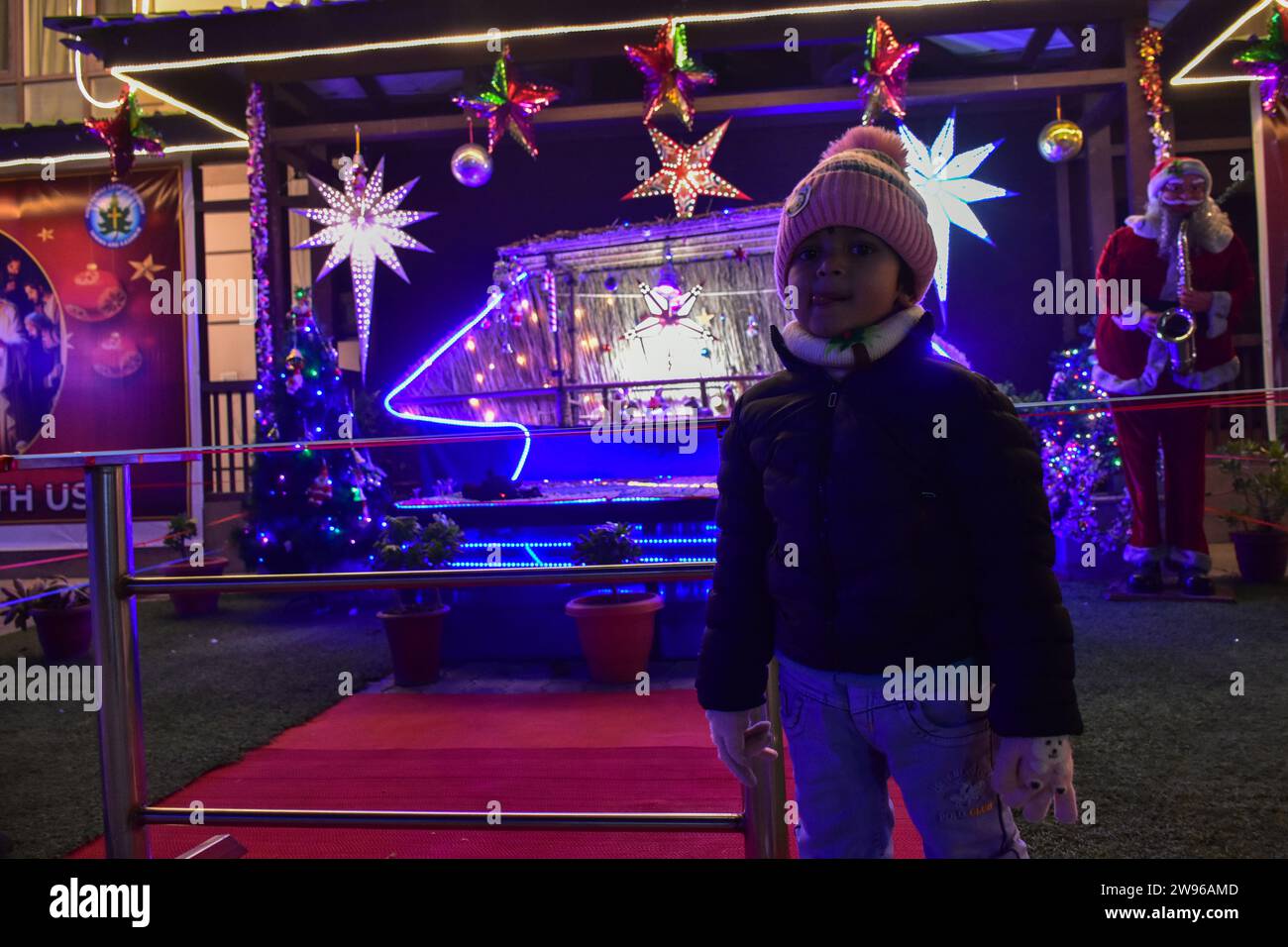 A Christian poses for the picture in front of the Santa Clause figure ...
