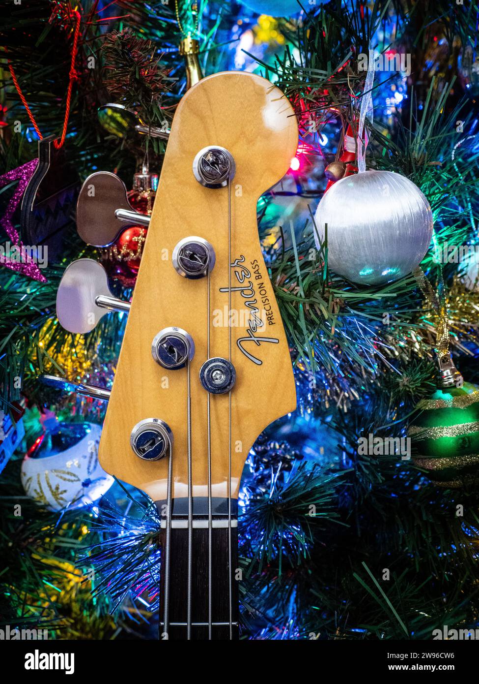 The headstock of a Fender Precision bass next to a christmas tree ...