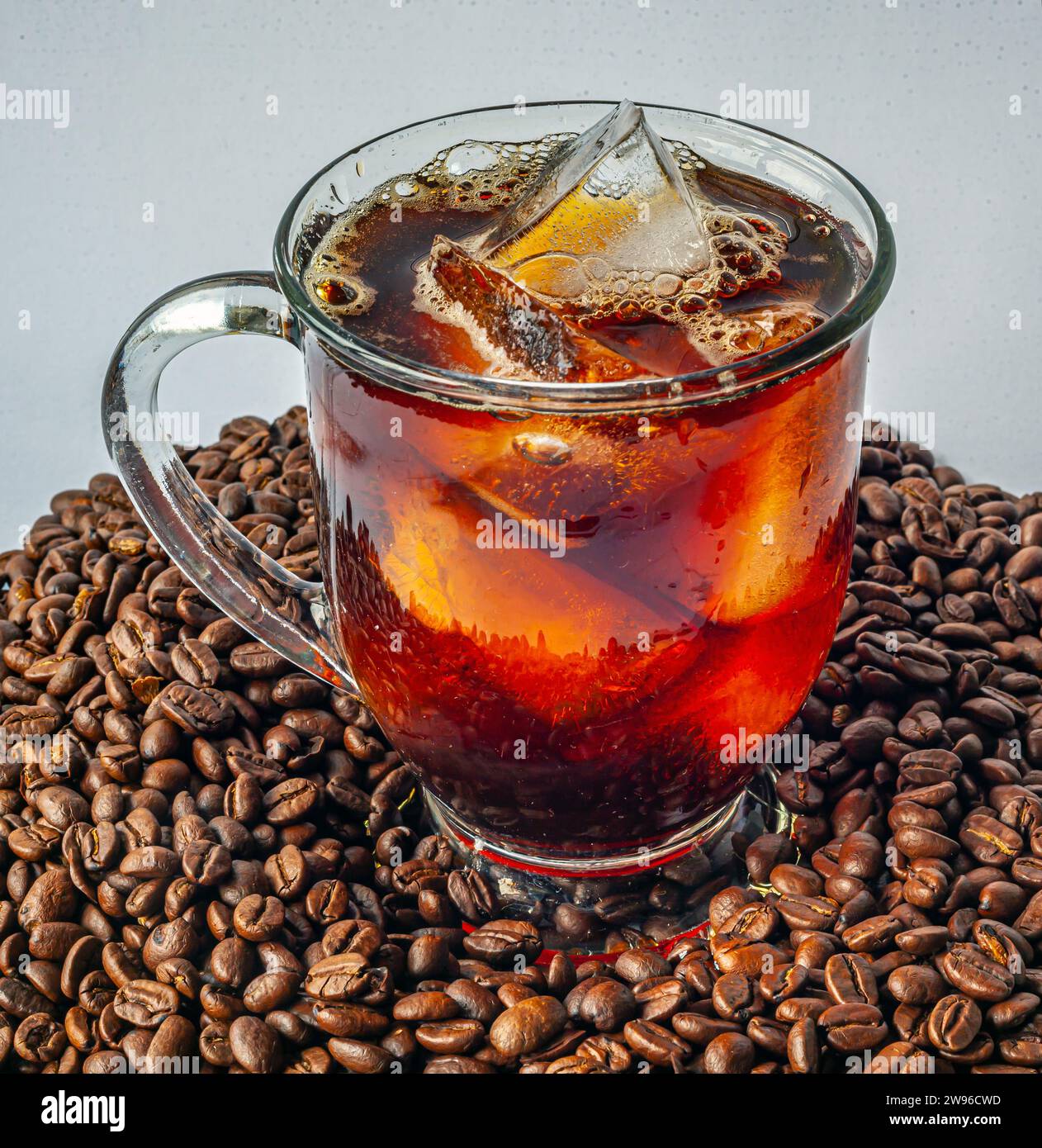 Cup of iced coffee on pile of freshly roasted boffee Stock Photo - Alamy