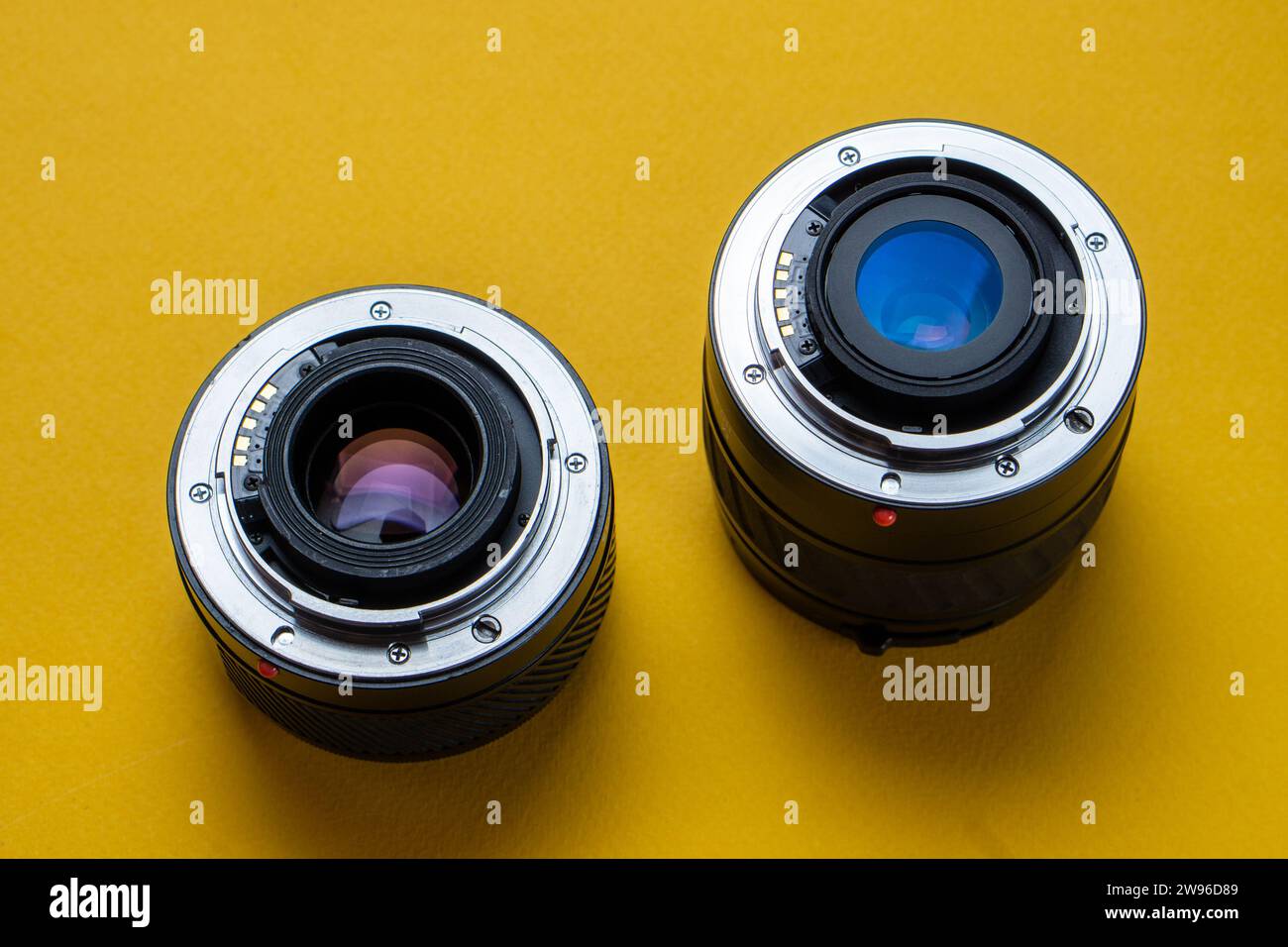 Camera lenses on a yellow background. Optical devices for image ...