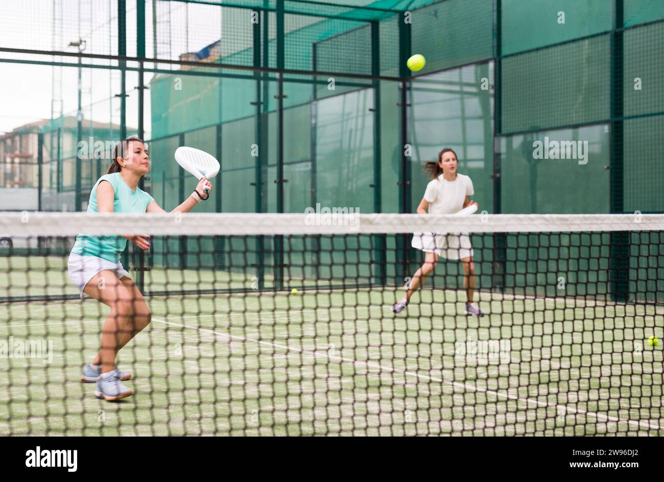 Two sports couples playing padel on the tennis court Stock Photo - Alamy